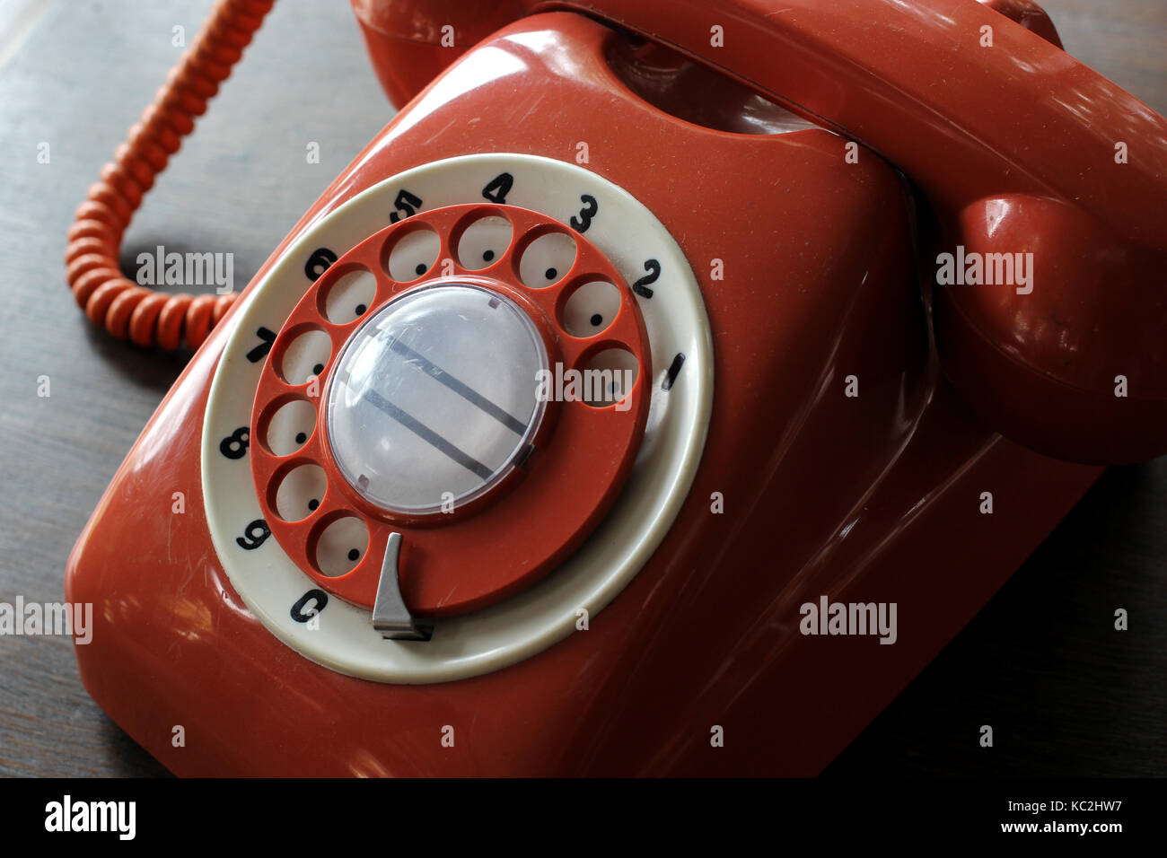 old dirty orange telephone on wooden table Stock Photo - Alamy