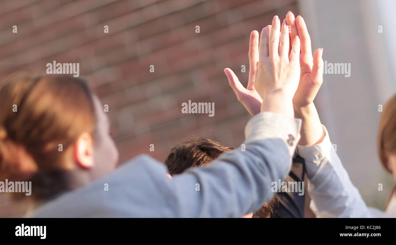 successful business team giving each other a high five Stock Photo - Alamy