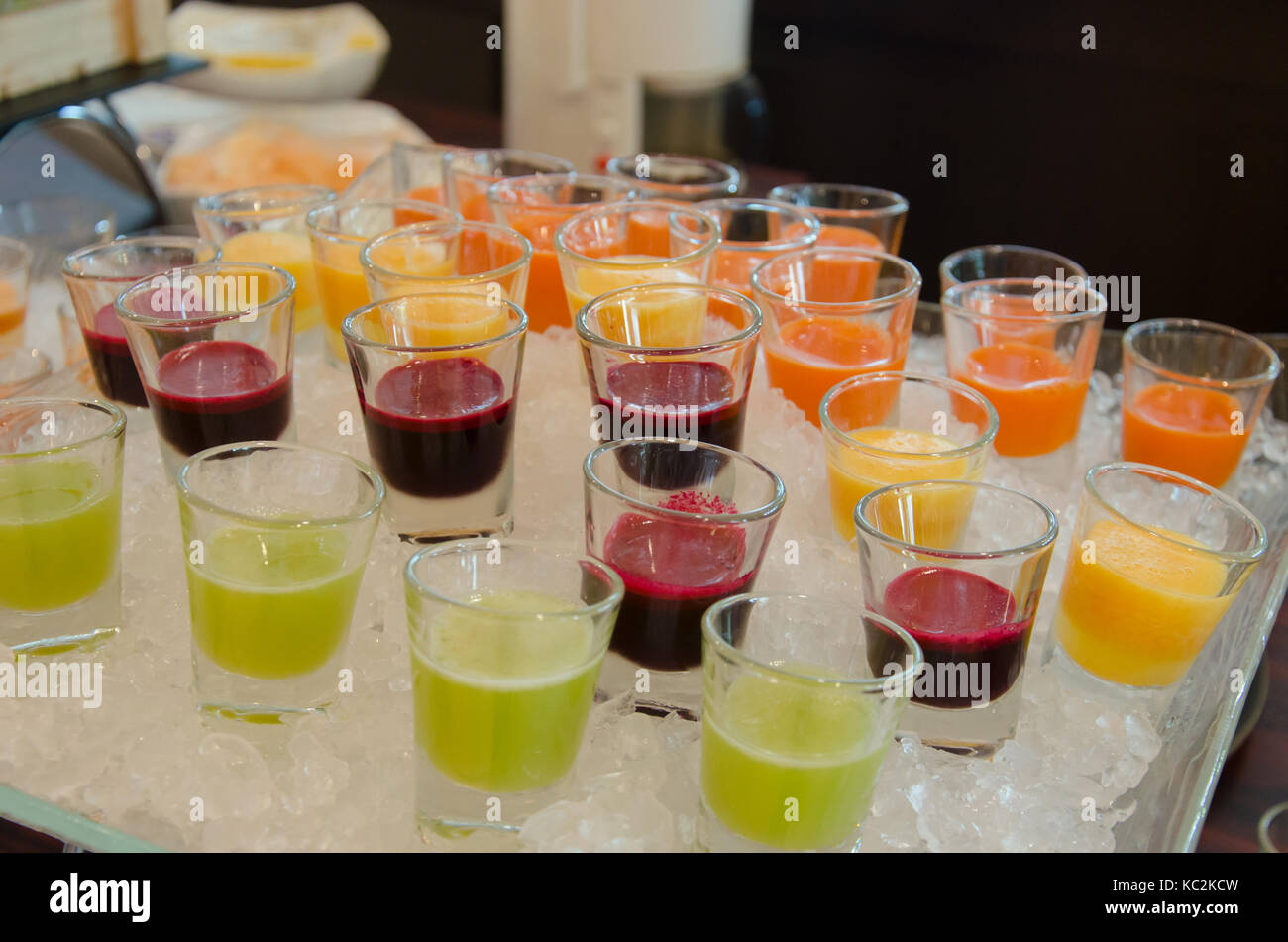 Fresh and healthy fruit juice in cups on cold ice Stock Photo - Alamy