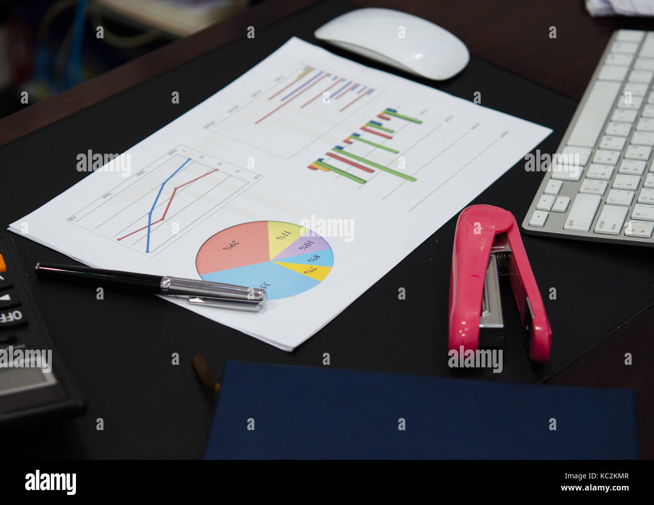 business graph Calculator and pen keyboard on the desk Stock Photo - Alamy