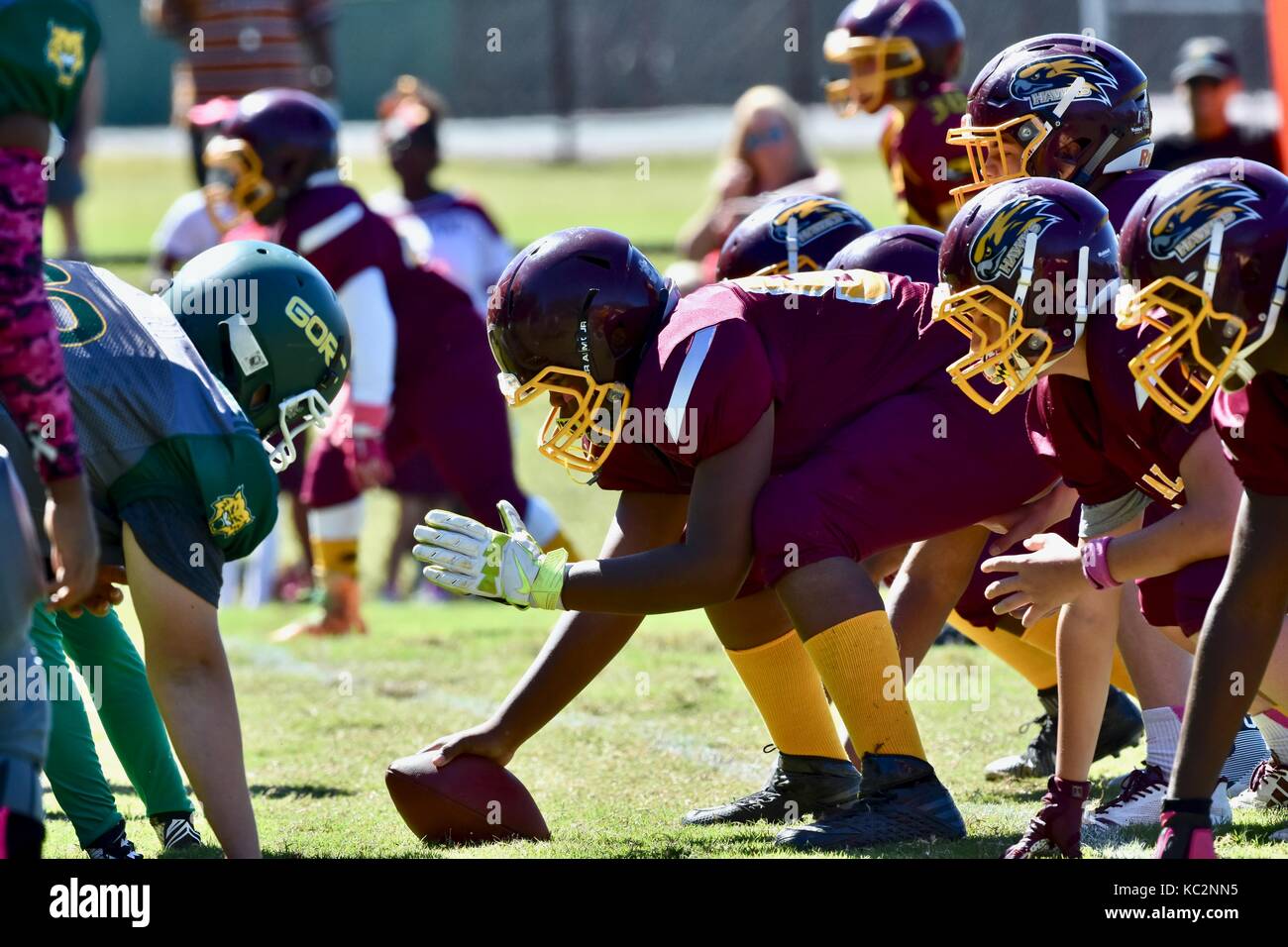 American football snapper with ball just before ball is snapped Stock ...