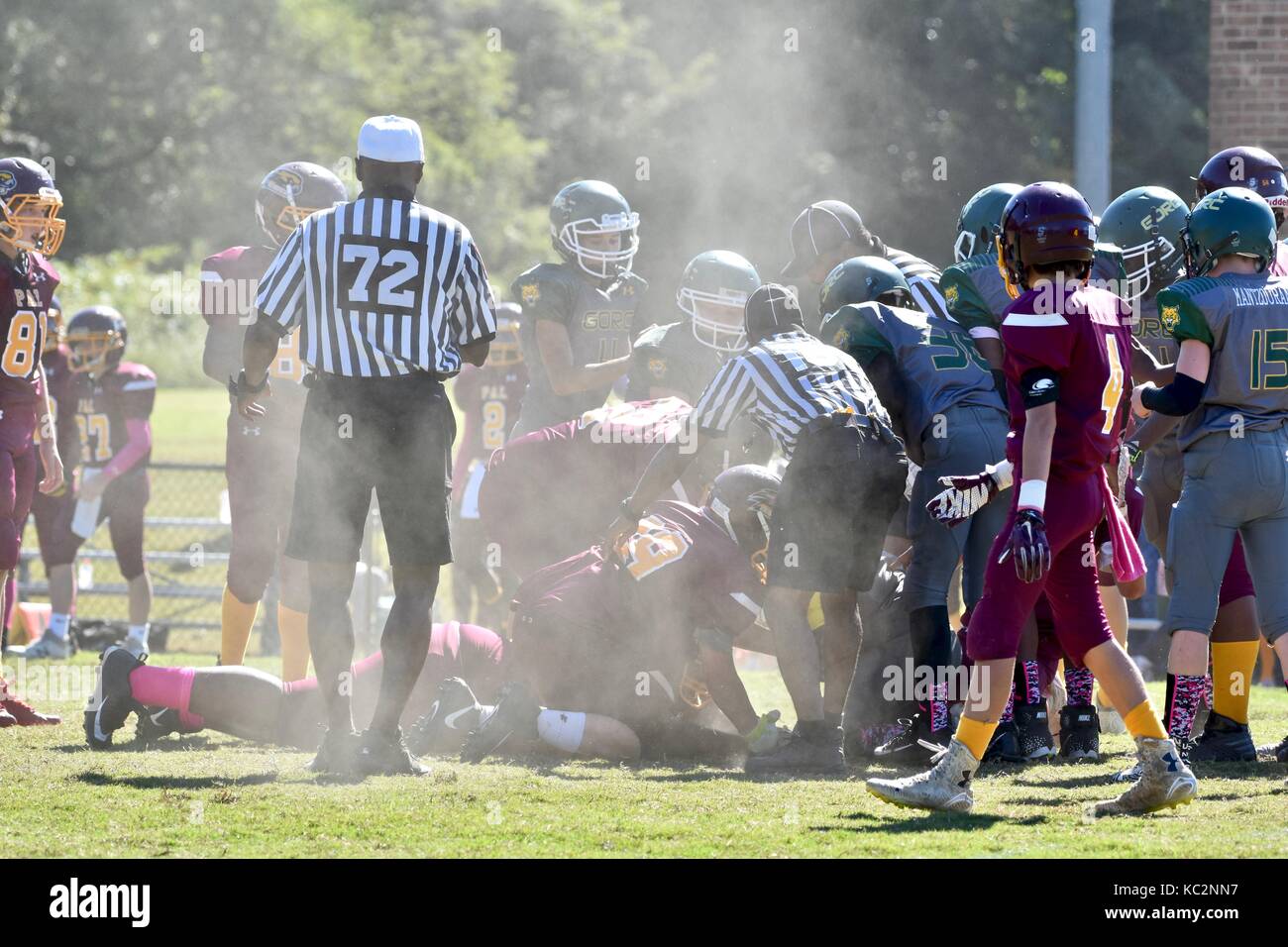 American football sport game with dust coming from the ground after a ...