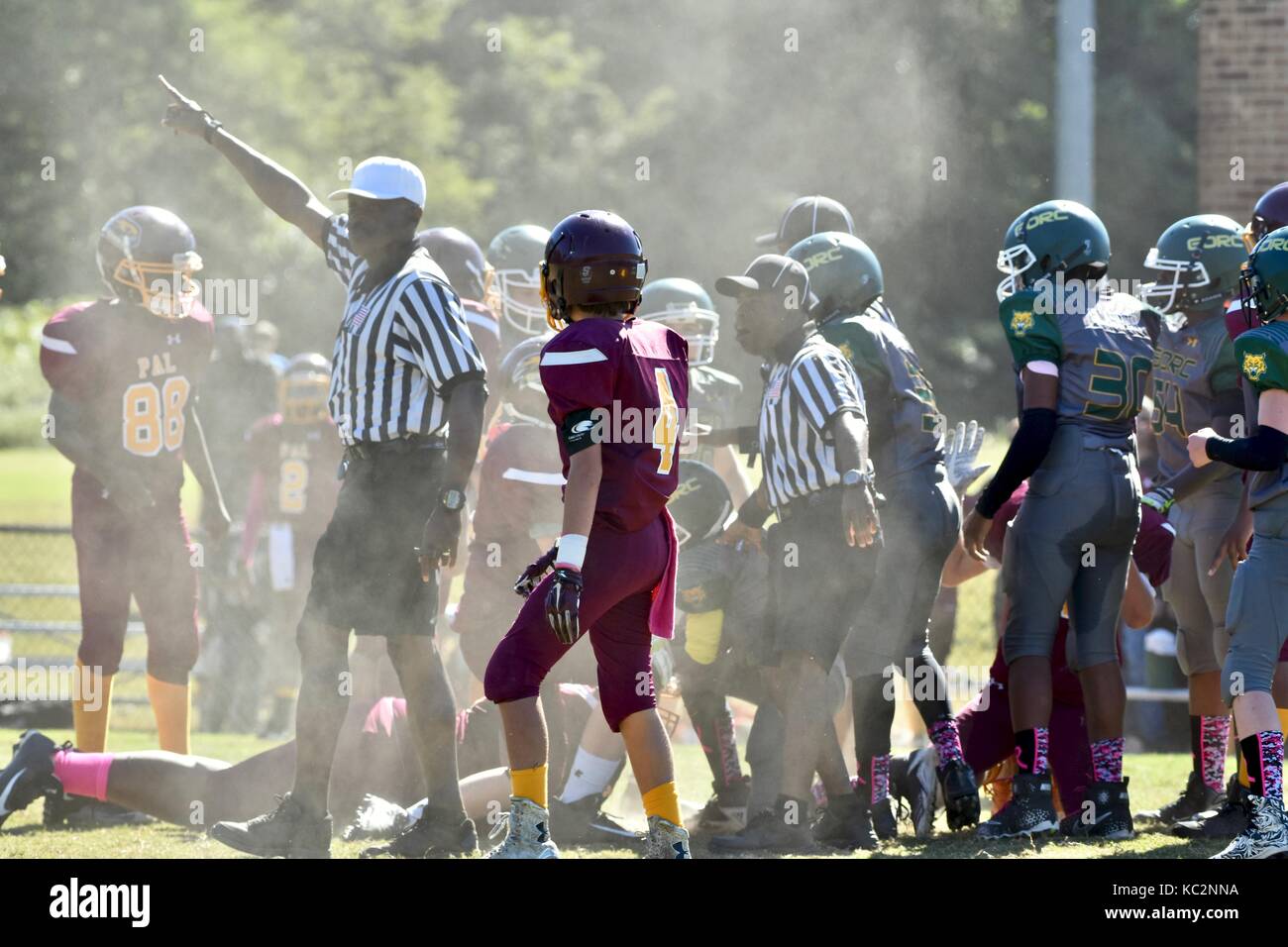 American football sport game with dust coming from the ground after a ...