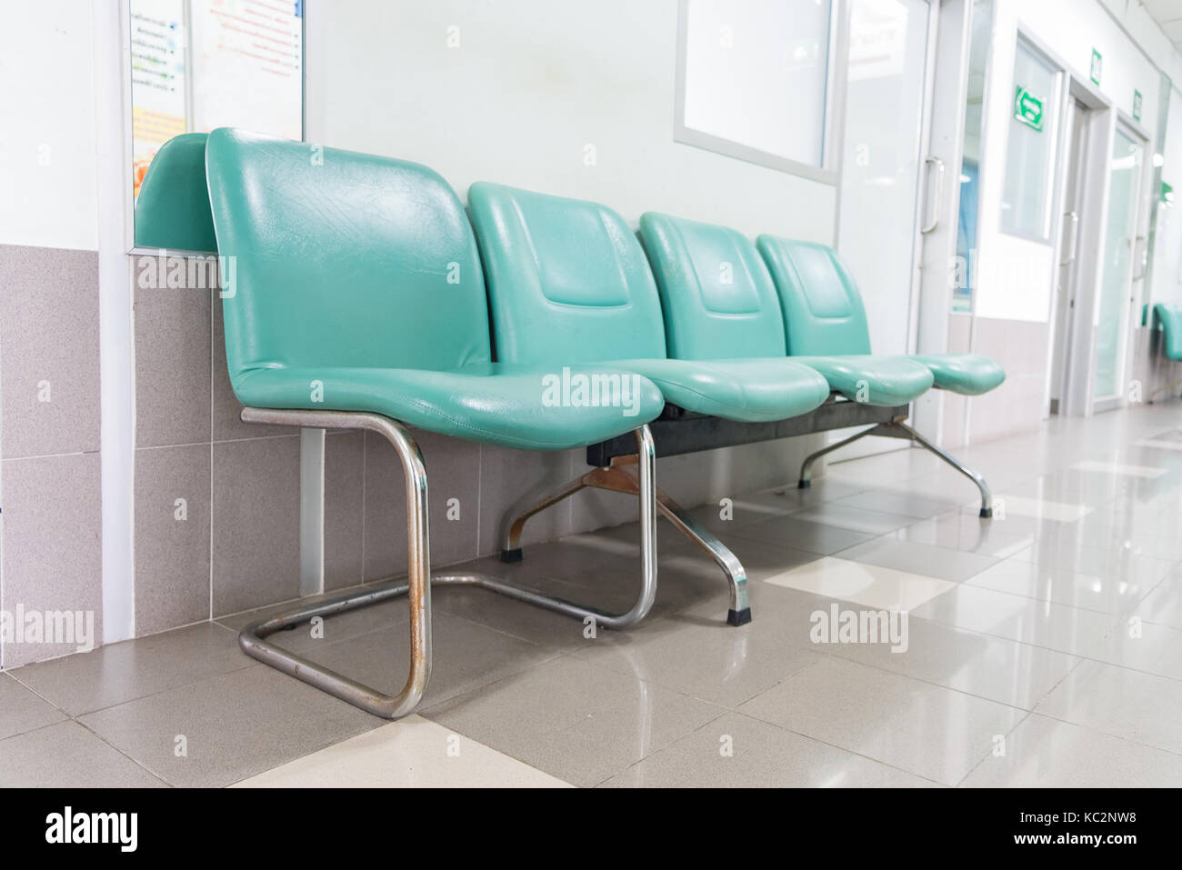 Empty green waiting chair in the hospital hallway. interior of clean ...