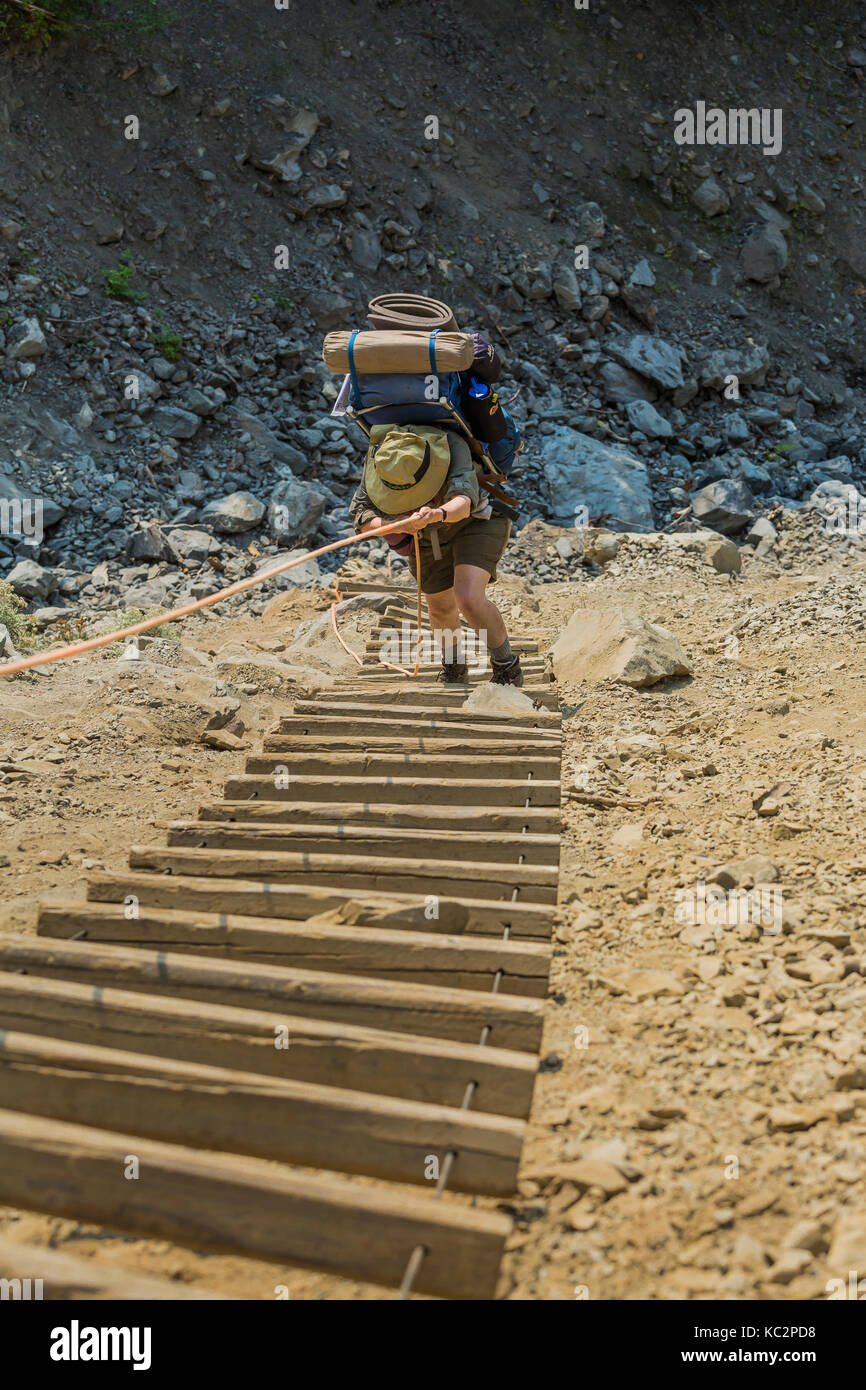 Backpacker Karen Rentz descending a long, steep rope ladder along the ...