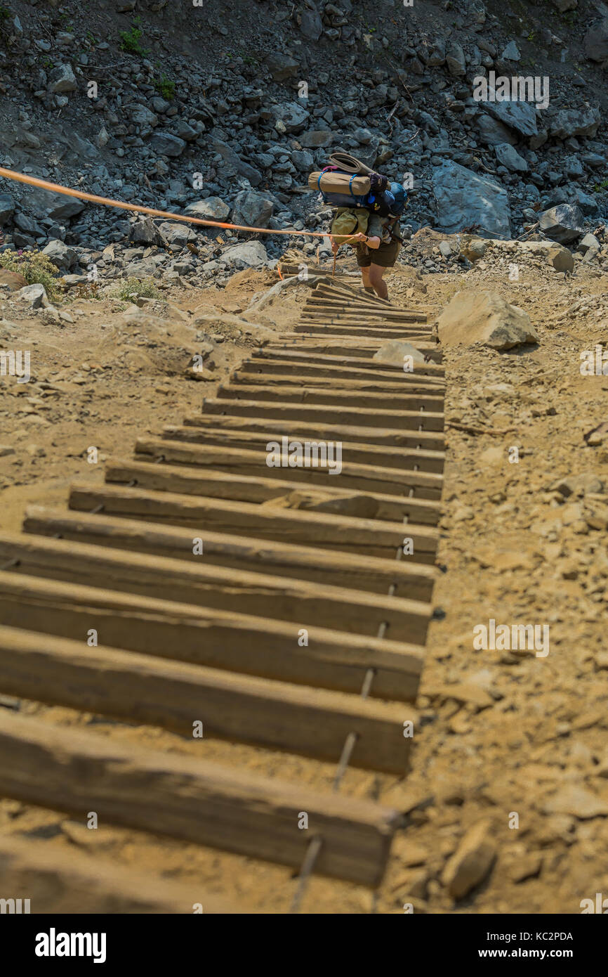 Backpacker Karen Rentz descending a long, steep rope ladder along the ...