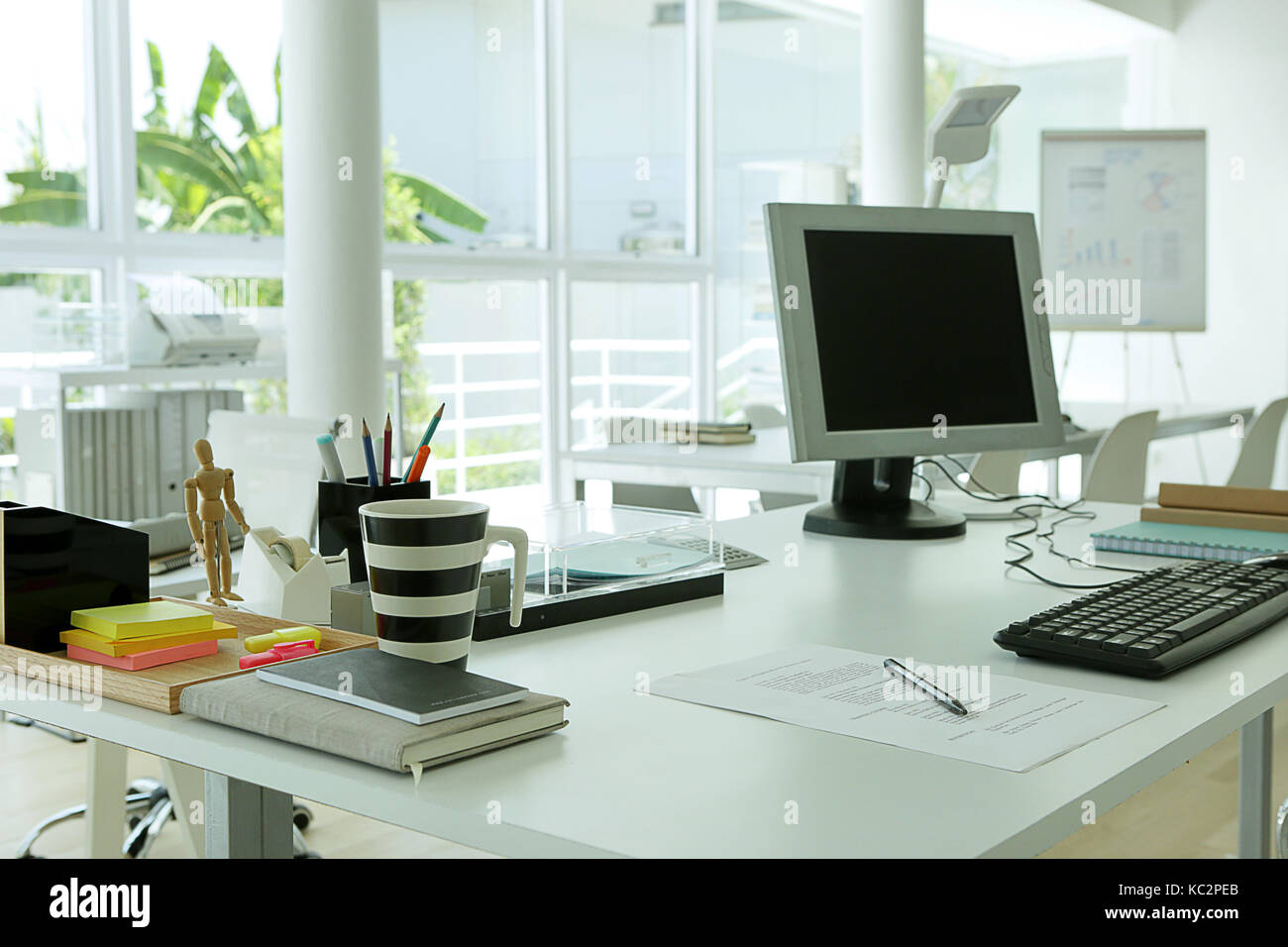 a work paper ready on modern white desk station in modern loft office ...