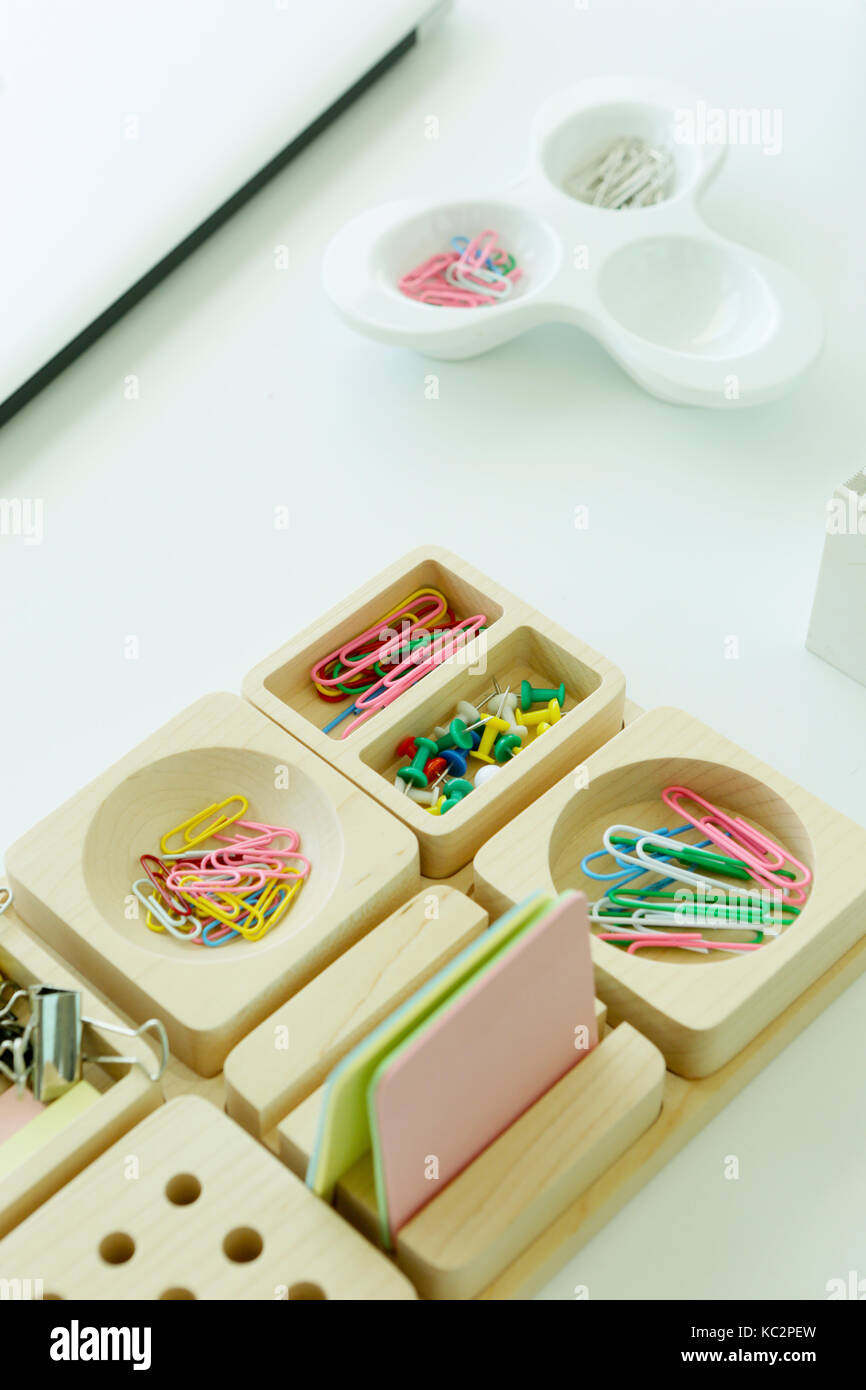 a lot of paper clips in difference color on the white desk office Stock ...