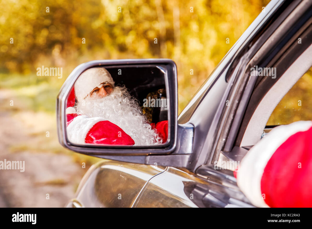 Authentic Santa Claus. Santa Claus drives a car through the autumn ...