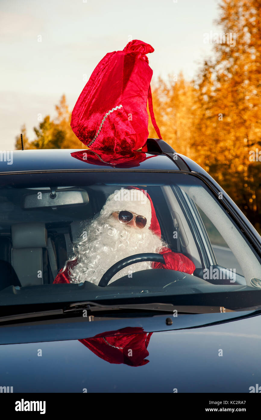 Authentic Santa Claus. Santa Claus drives a car through the autumn ...