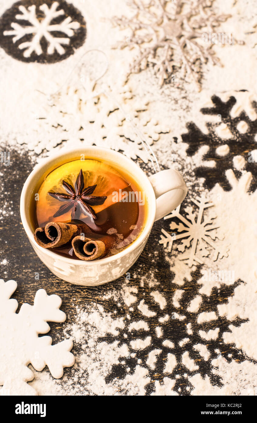 Cup of Tea with a Lemon and Cinnamon on Christmas background with snow ...