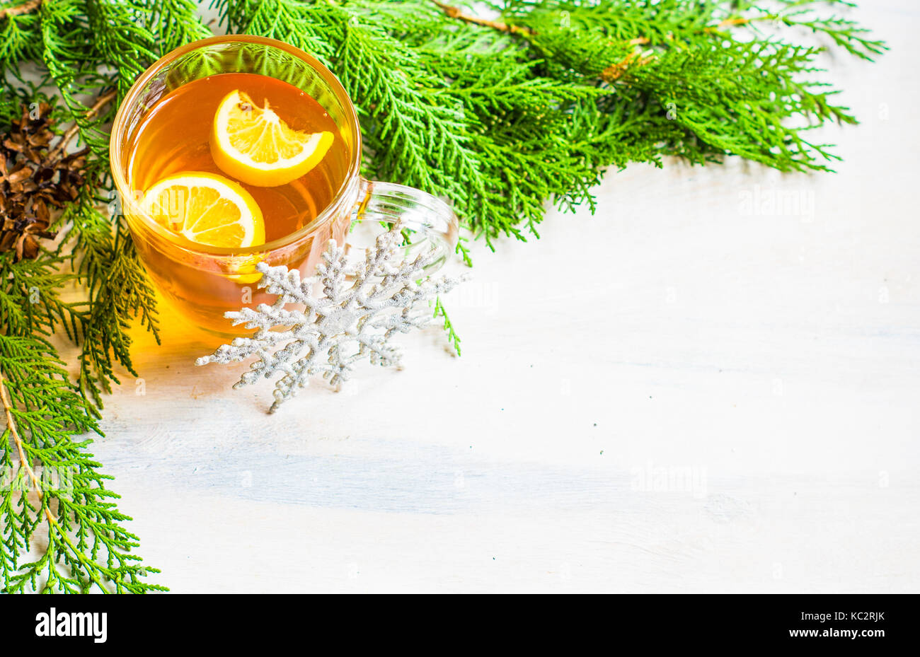 Cup of Tea with a Lemon and Cinnamon on Christmas background with snow ...
