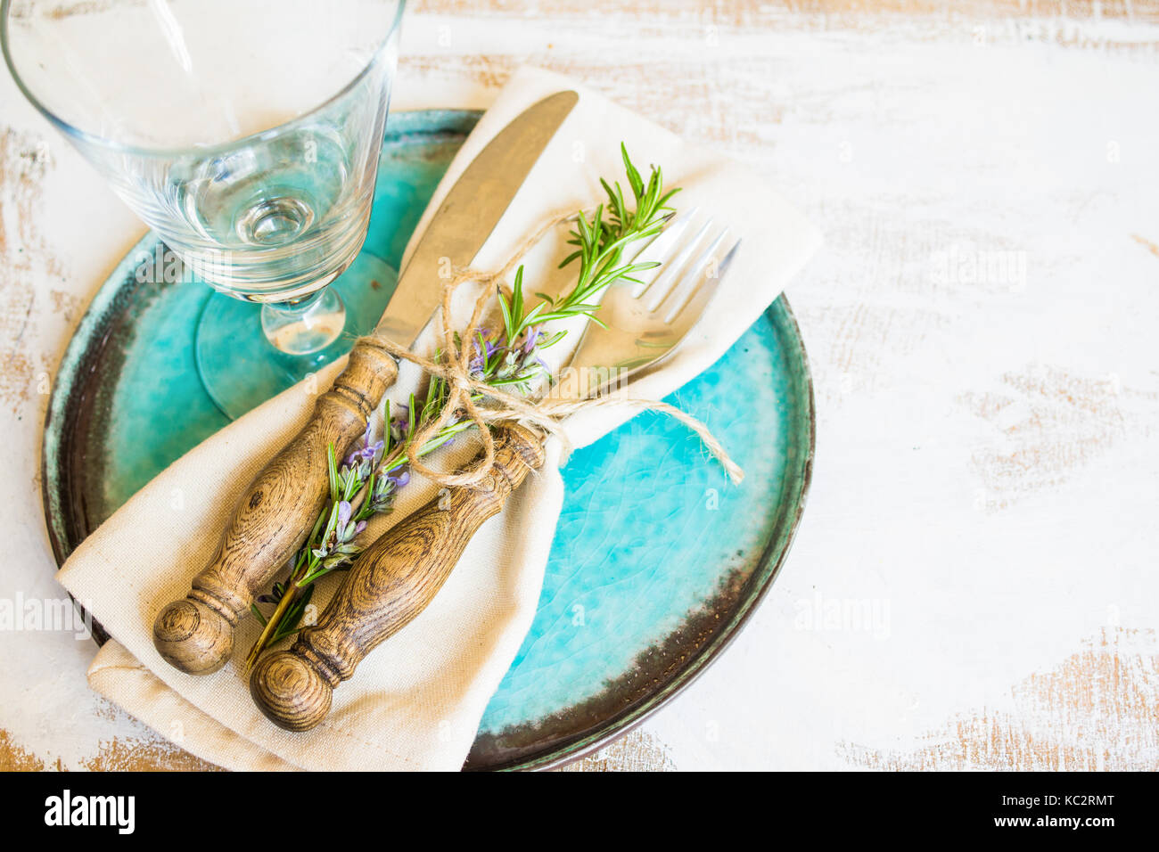 Summer time table setting with fresh rosemary spice on rustic ...