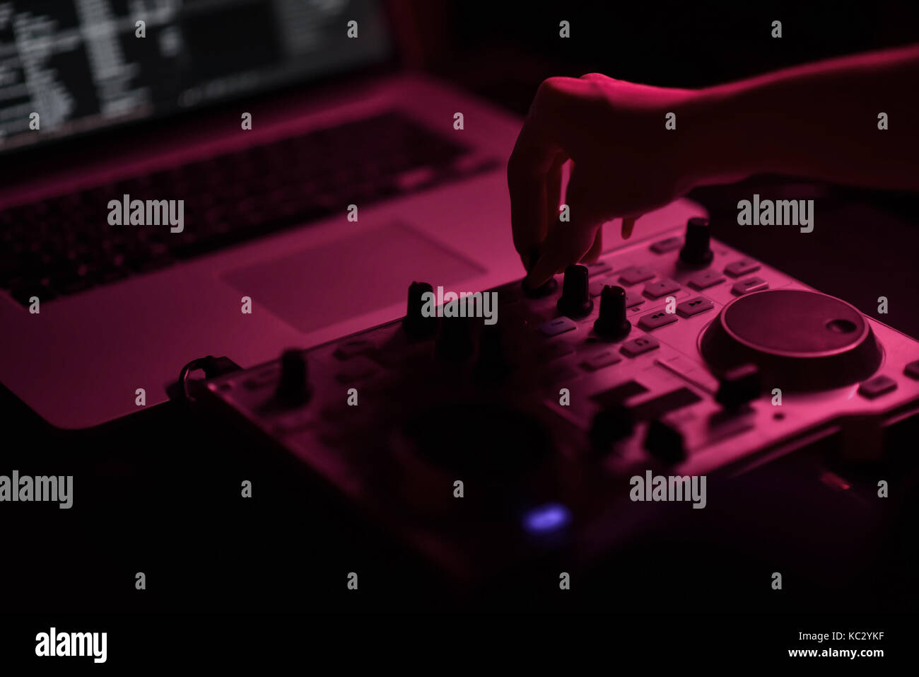 DJ mixer disco illuminated by searchlights Stock Photo - Alamy