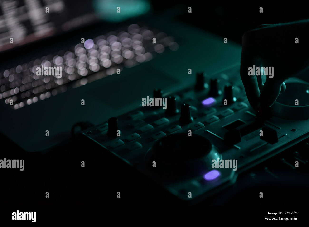 DJ mixer disco illuminated by searchlights Stock Photo - Alamy