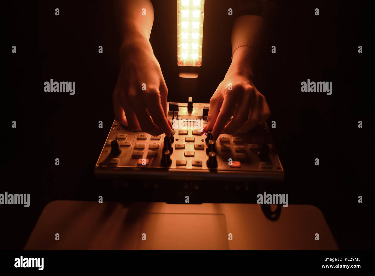 DJ mixer disco illuminated by searchlights Stock Photo - Alamy