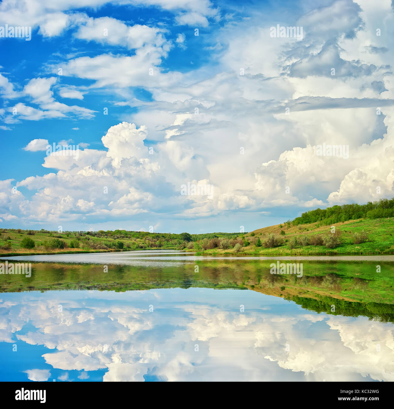 Lake and spring green hills. River in spring sunny day. Nature ...