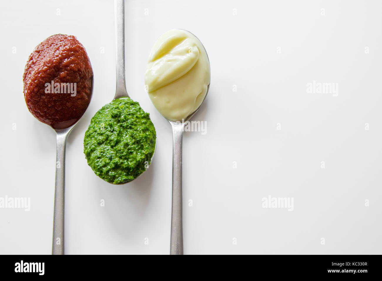 Top view of three spoons with different condiments Stock Photo - Alamy