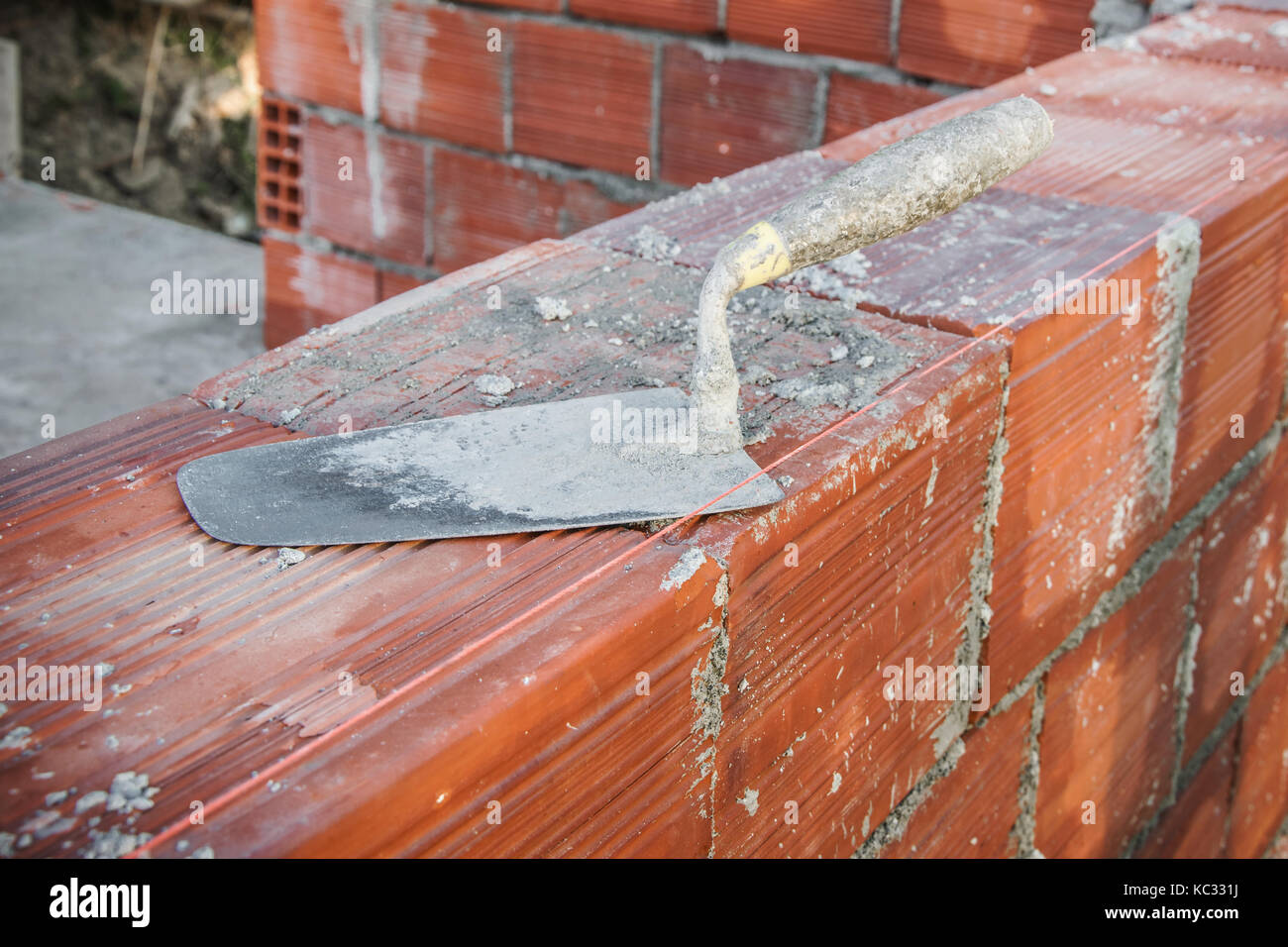 Red brick wall in construction Stock Photo - Alamy