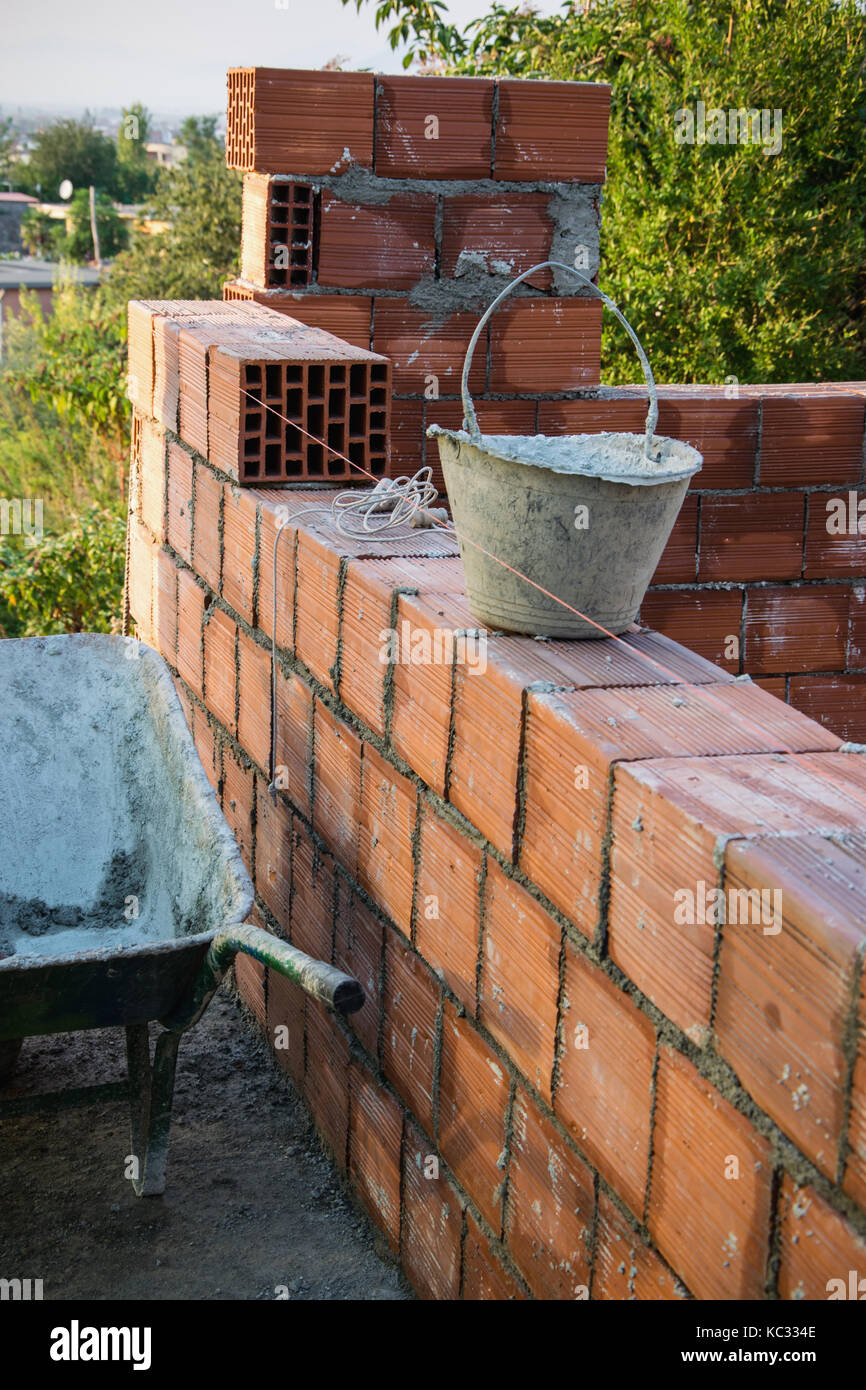 Red brick wall in construction Stock Photo - Alamy