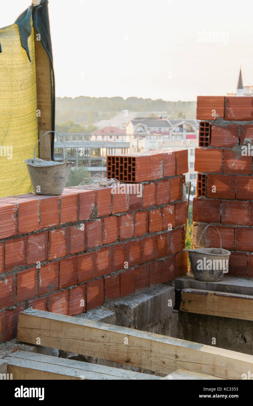 Red brick wall in construction Stock Photo - Alamy