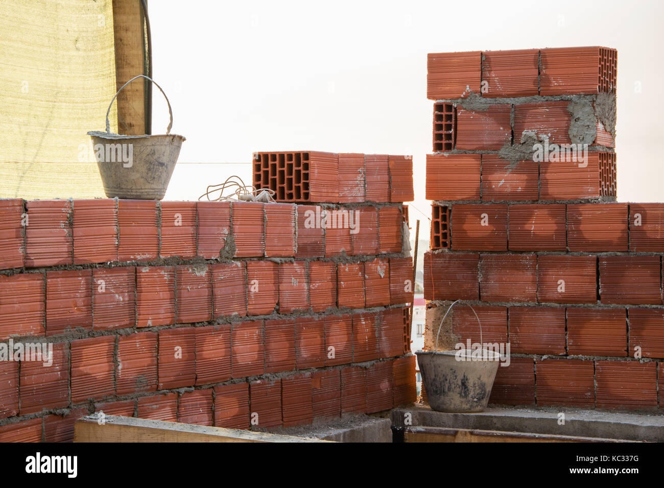 Red brick wall in construction Stock Photo - Alamy