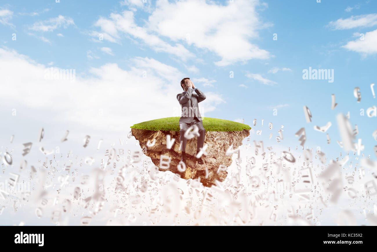 Young man floating in sky and do not want to see anything Stock Photo ...