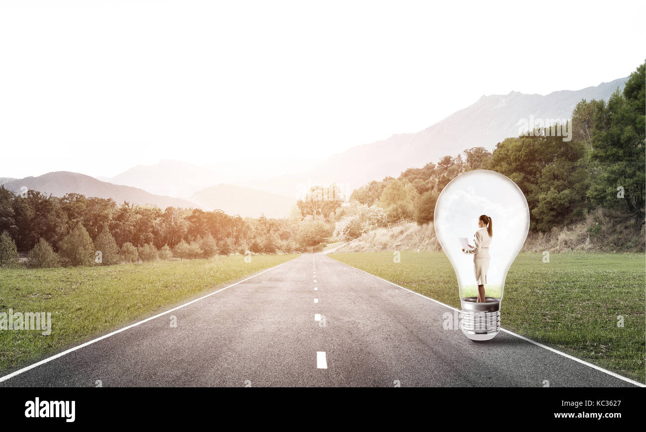 Businesswoman inside light bulb Stock Photo - Alamy