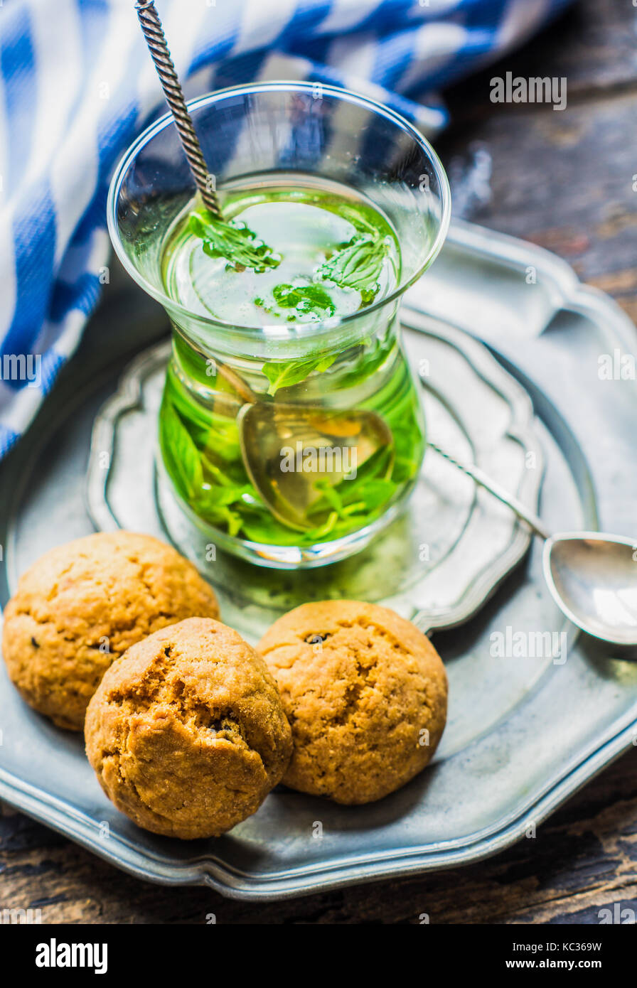 Eastern tea with mint and arabian sweets on wooden rustic table Stock ...
