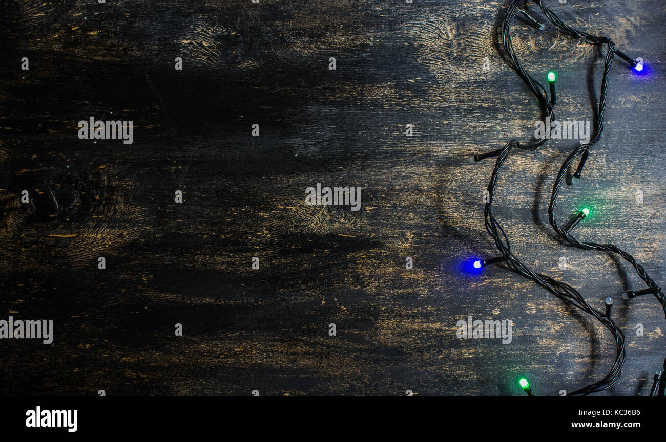 Christmas lights on dark rustic background Stock Photo - Alamy