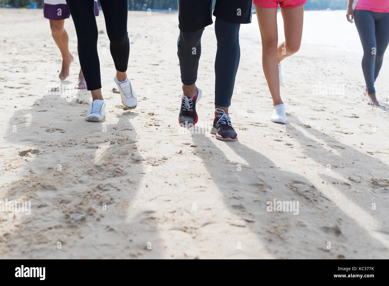 Group Of Young People Running On Beach Feet Closeup Sport Runners ...