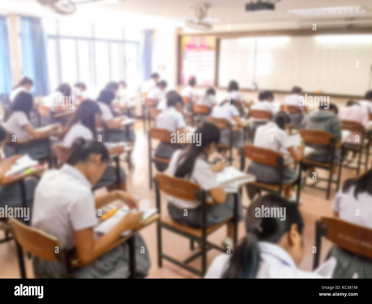 Blur school or university students writing answer doing exam in ...