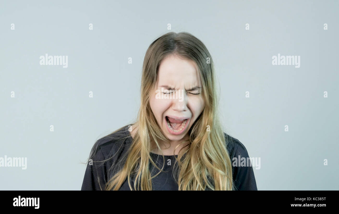 Pretty young beautiful woman loud screaming and smiling isolated over ...