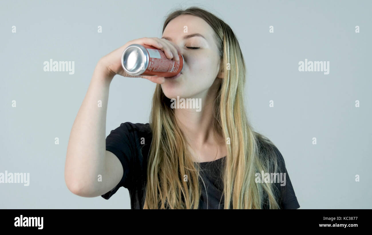 Young woman drinking a soda.Young beautiful woman drinking soda and ...