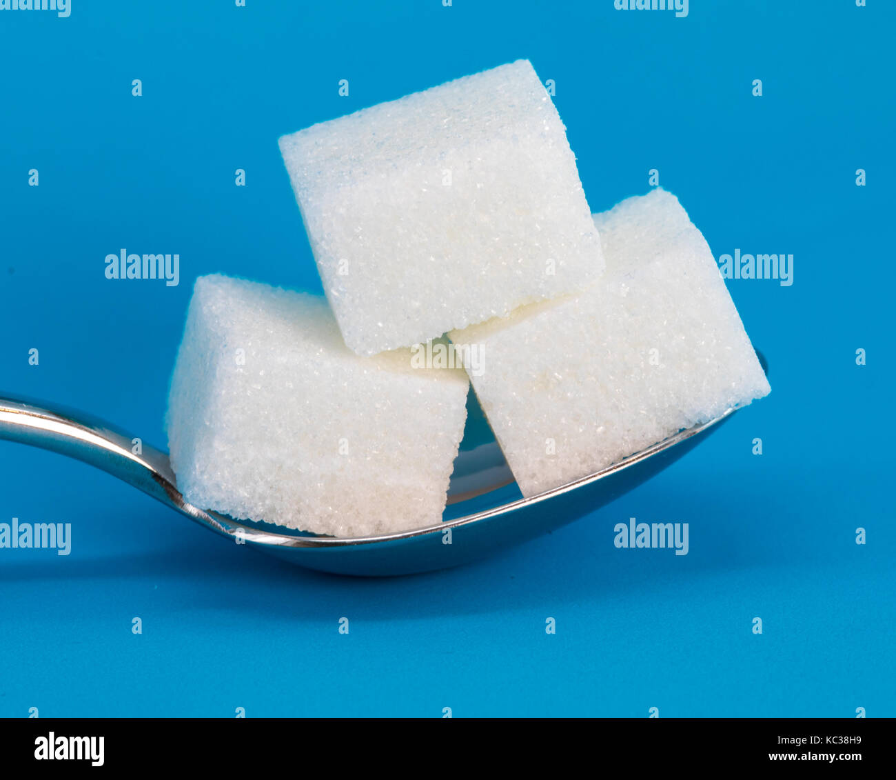 Sugar and sugar lumps on a tea spoon Stock Photo - Alamy
