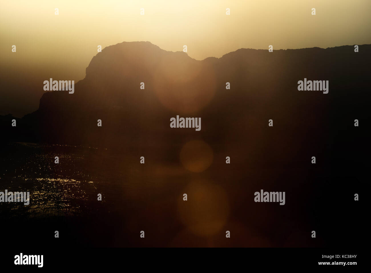 sun flare and rock Stock Photo - Alamy