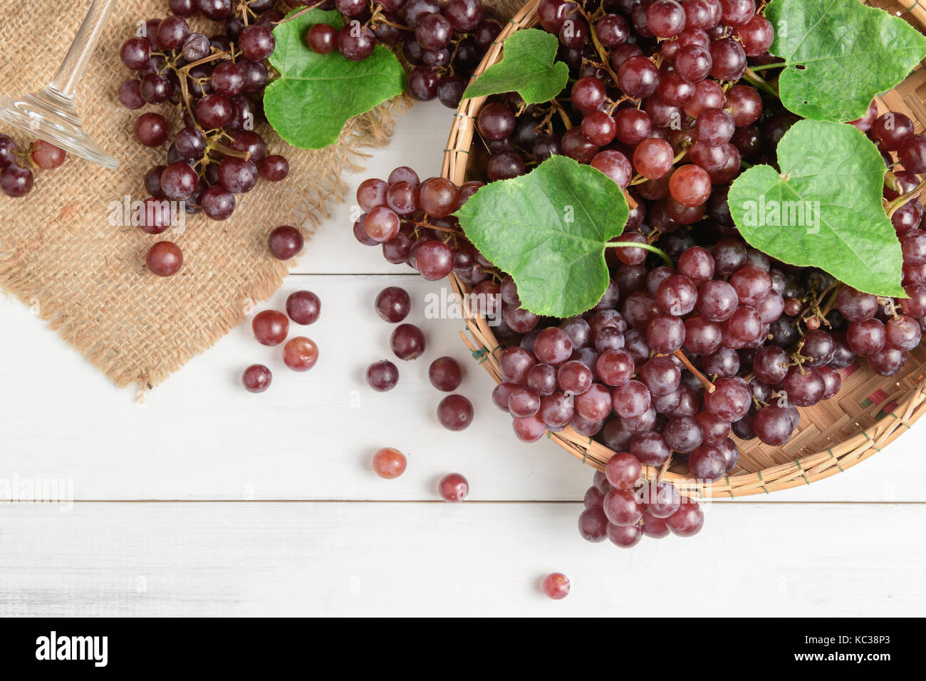 Fresh champagne Grapes on bamboo basket and vintage white background ...