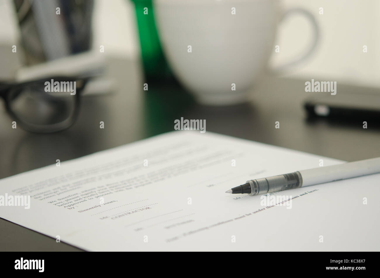 Pen and paper to sign the contract Stock Photo - Alamy
