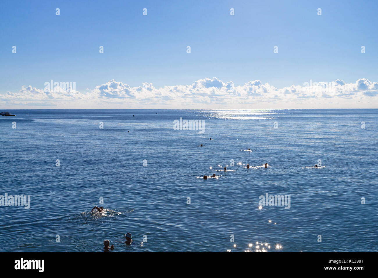 travel to Crimea - swimming tourists in Black Sea near urban beach in ...