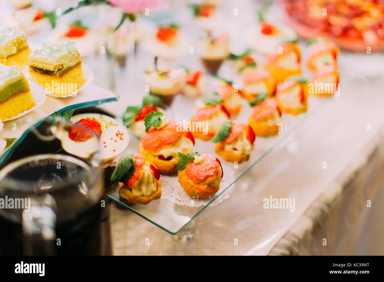 Delicious pastries with fruits are decorated with mint for wedding ...