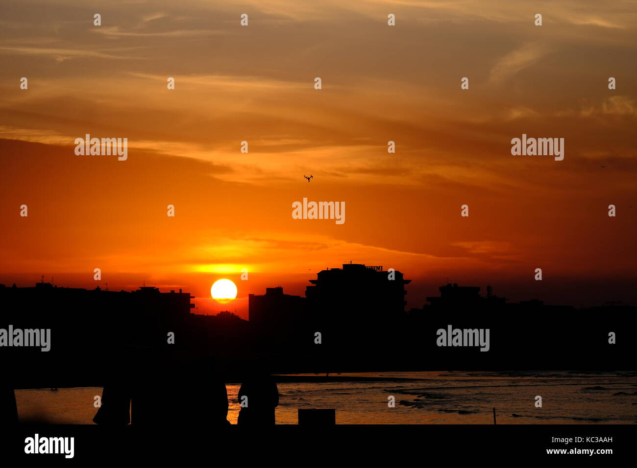 Drone camera being flown over beach at sunset, Rimini , Italy Stock ...