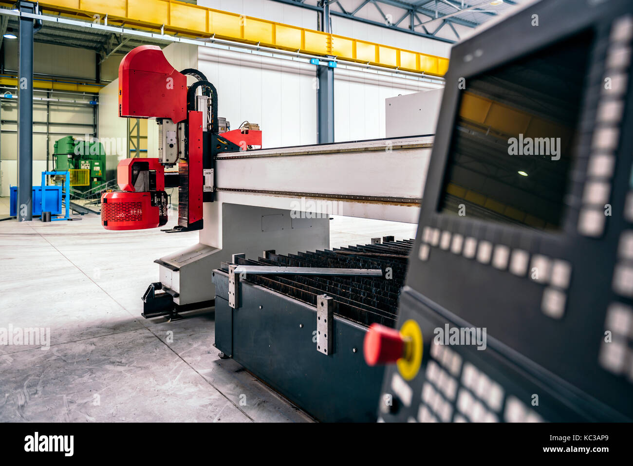 CNC Plasma cutter machine control panel in big metal industrial hall ...