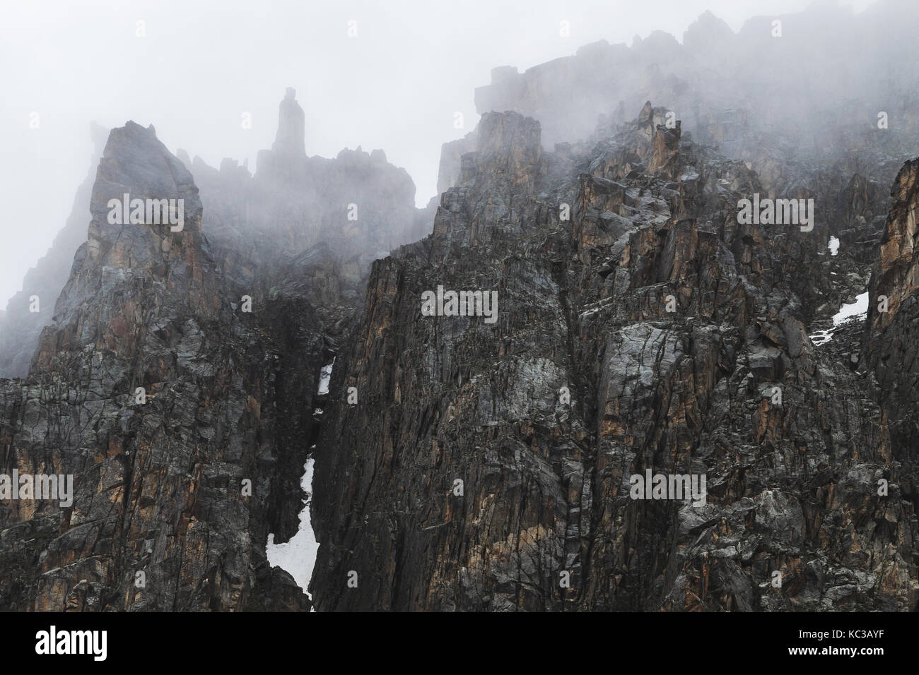 Mountain landscape with rocks and creeping fog. High peaks in the ...