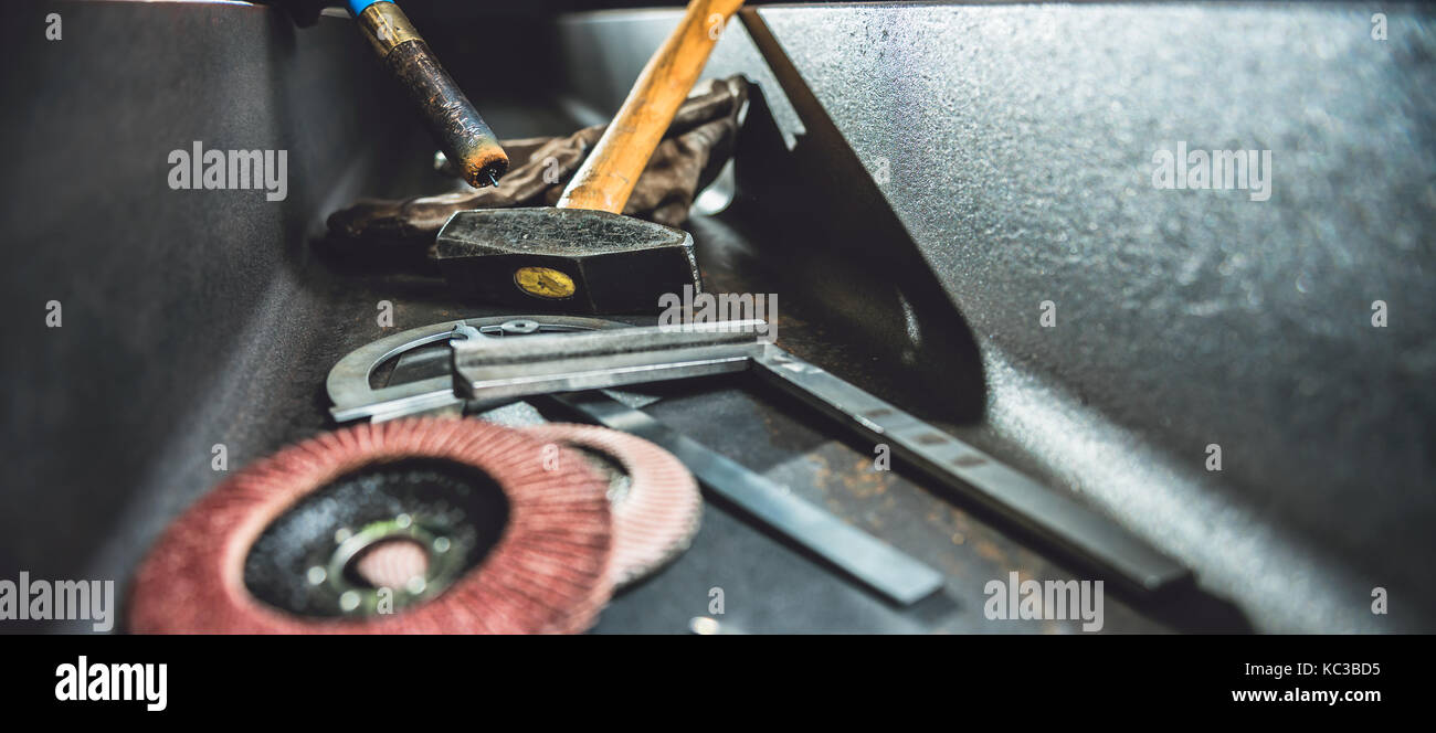 Industrial welding tool in big metal profile background Stock Photo - Alamy