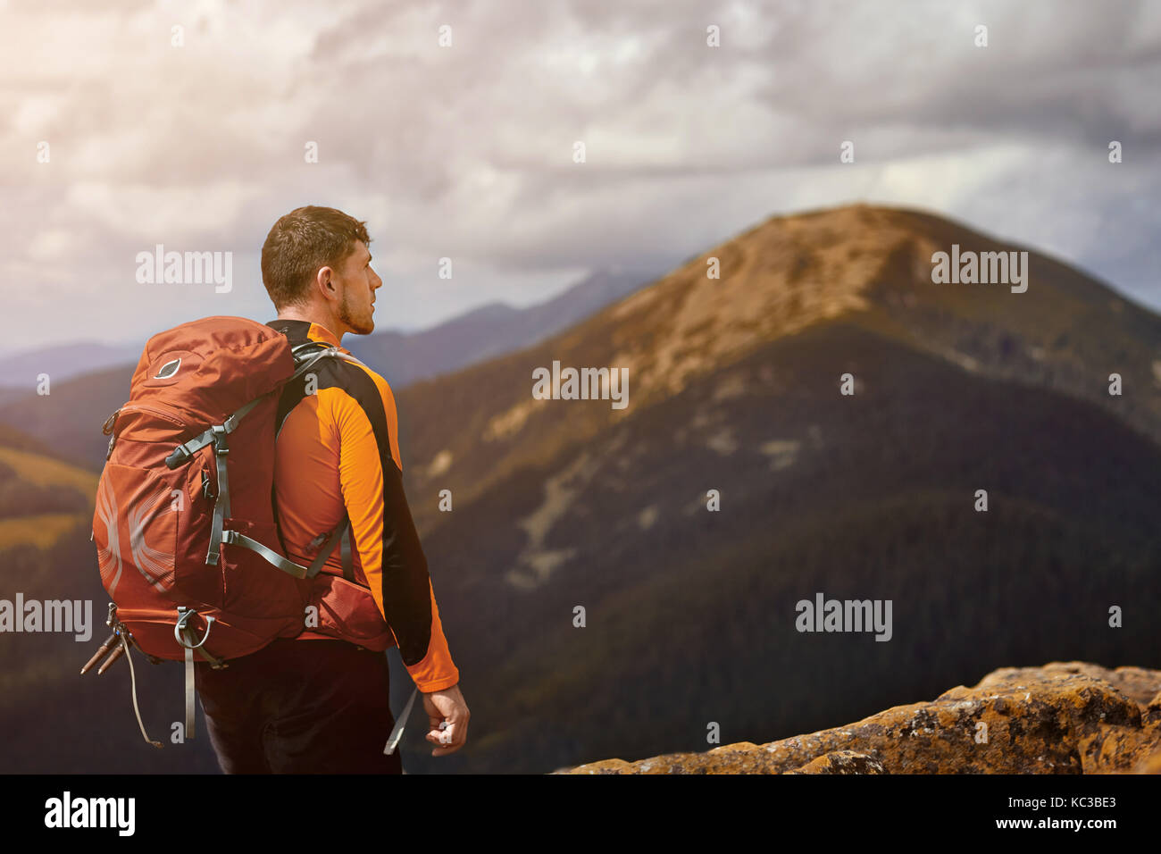Male traveler from back in the mountains Stock Photo - Alamy