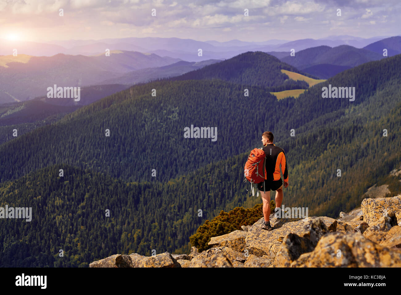 Male traveler from back in the mountains Stock Photo - Alamy