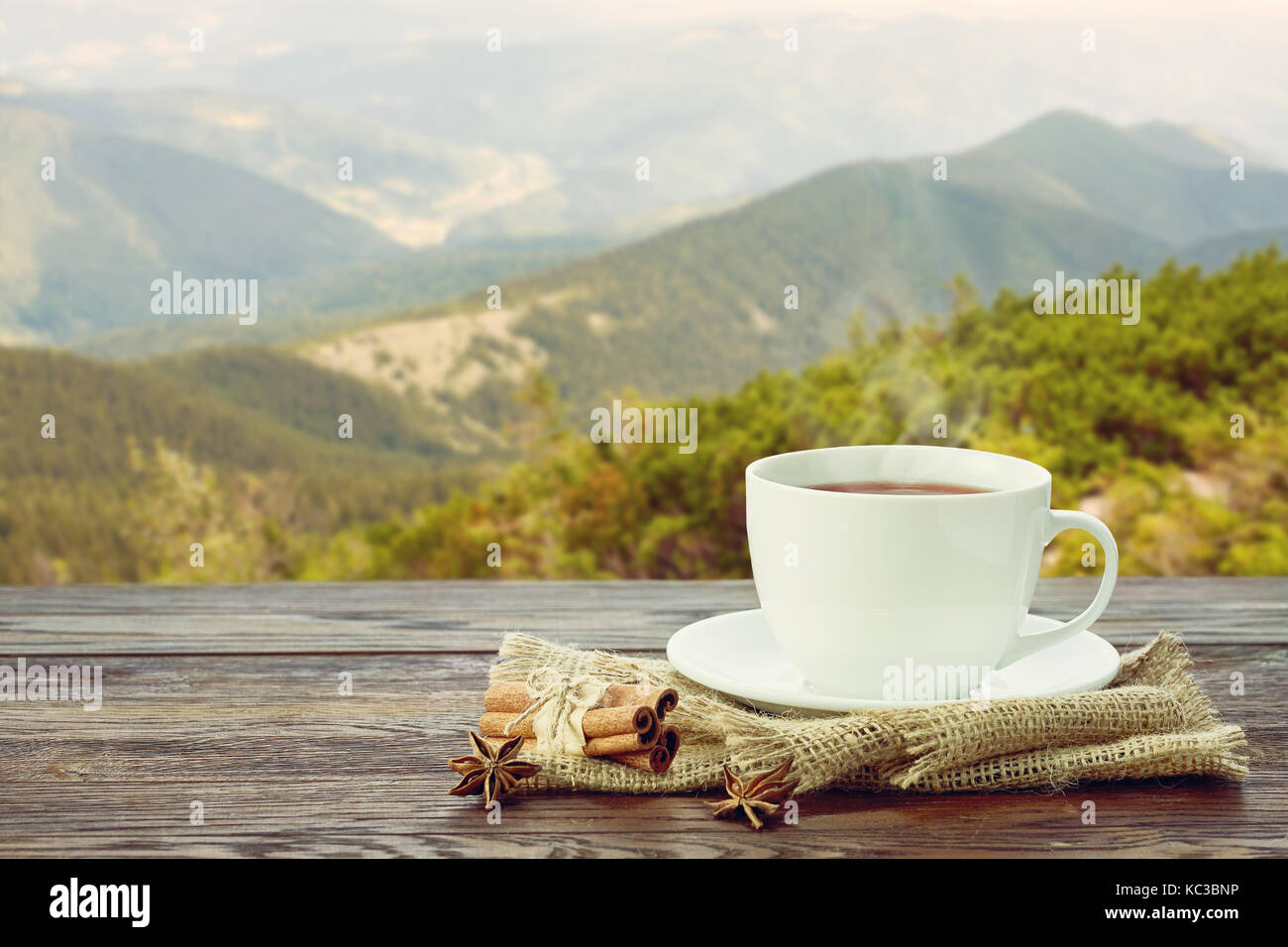 Cup with tea on table over mountains landscape with sunlight Stock ...