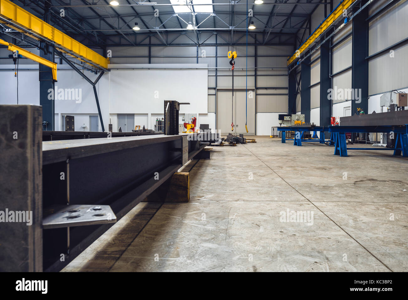 Industrial hall with cutting, welding machines and metal profiles with ...