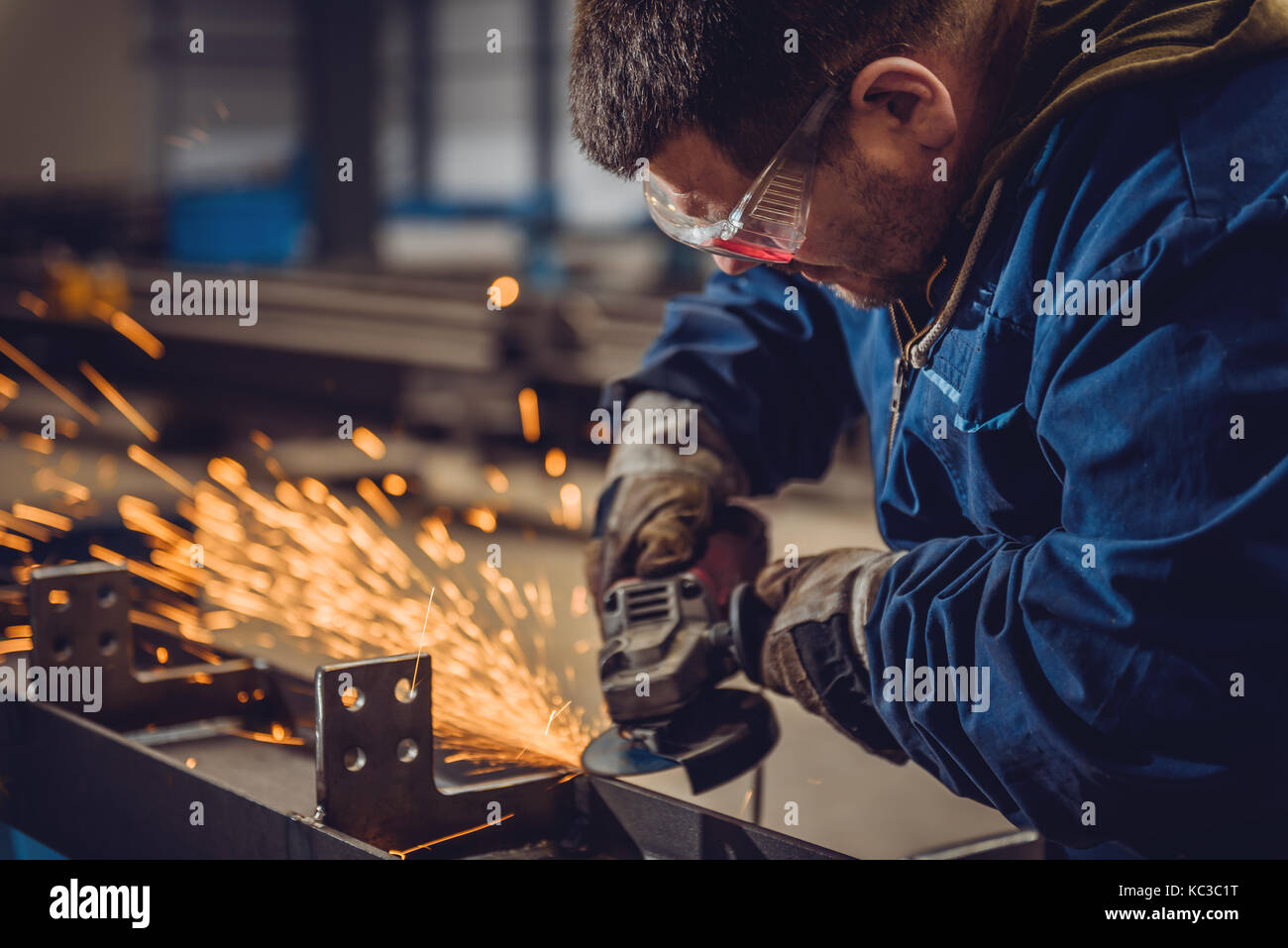 Worker Using Angle Grinder in Factory and throwing sparks Stock Photo ...