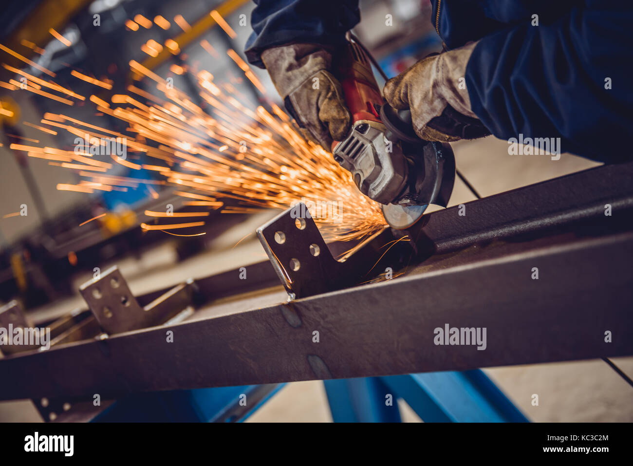 Worker Using Angle Grinder in Factory and throwing sparks Stock Photo ...
